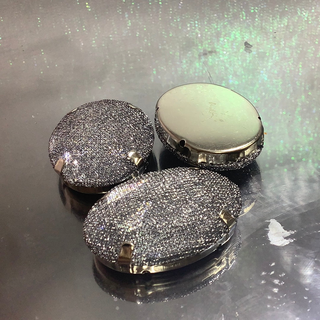 Oval shaped button with mesh over it – www.jimmybuttons.com.au